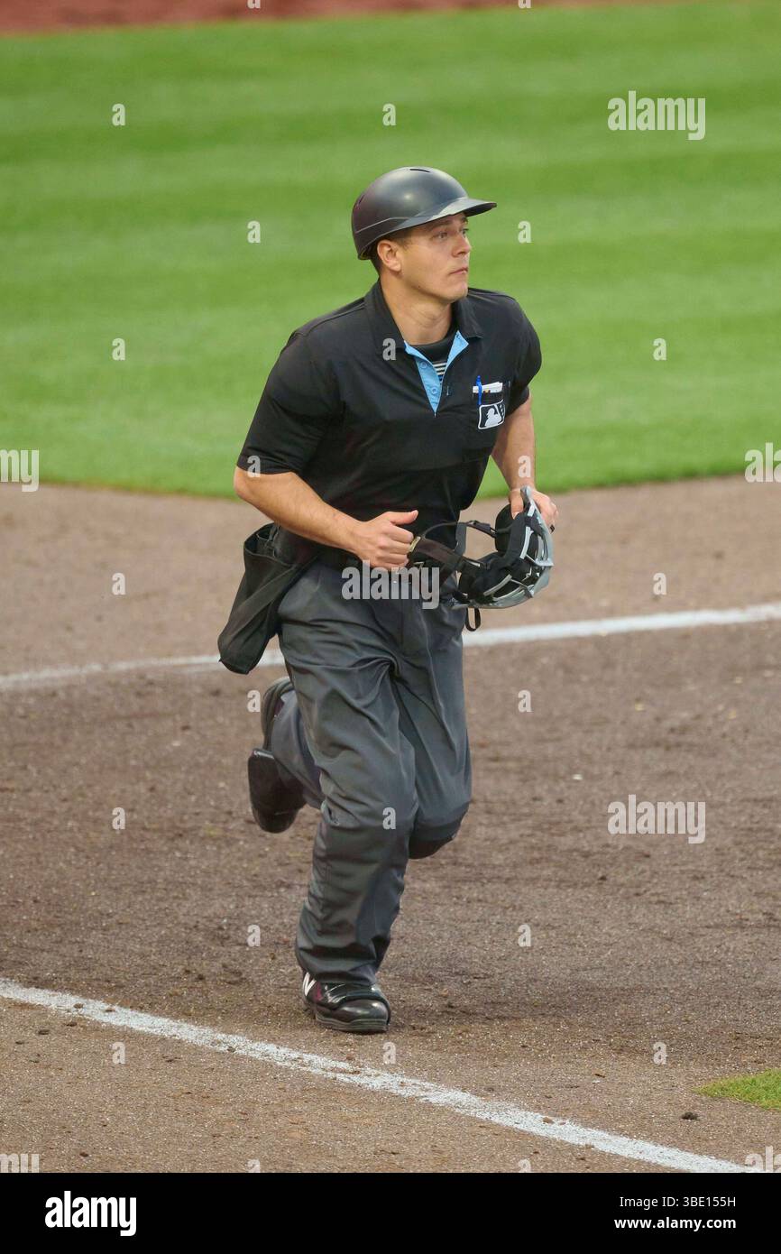 Umpire Steven Rios Jr. heads down the first base line in action between ...