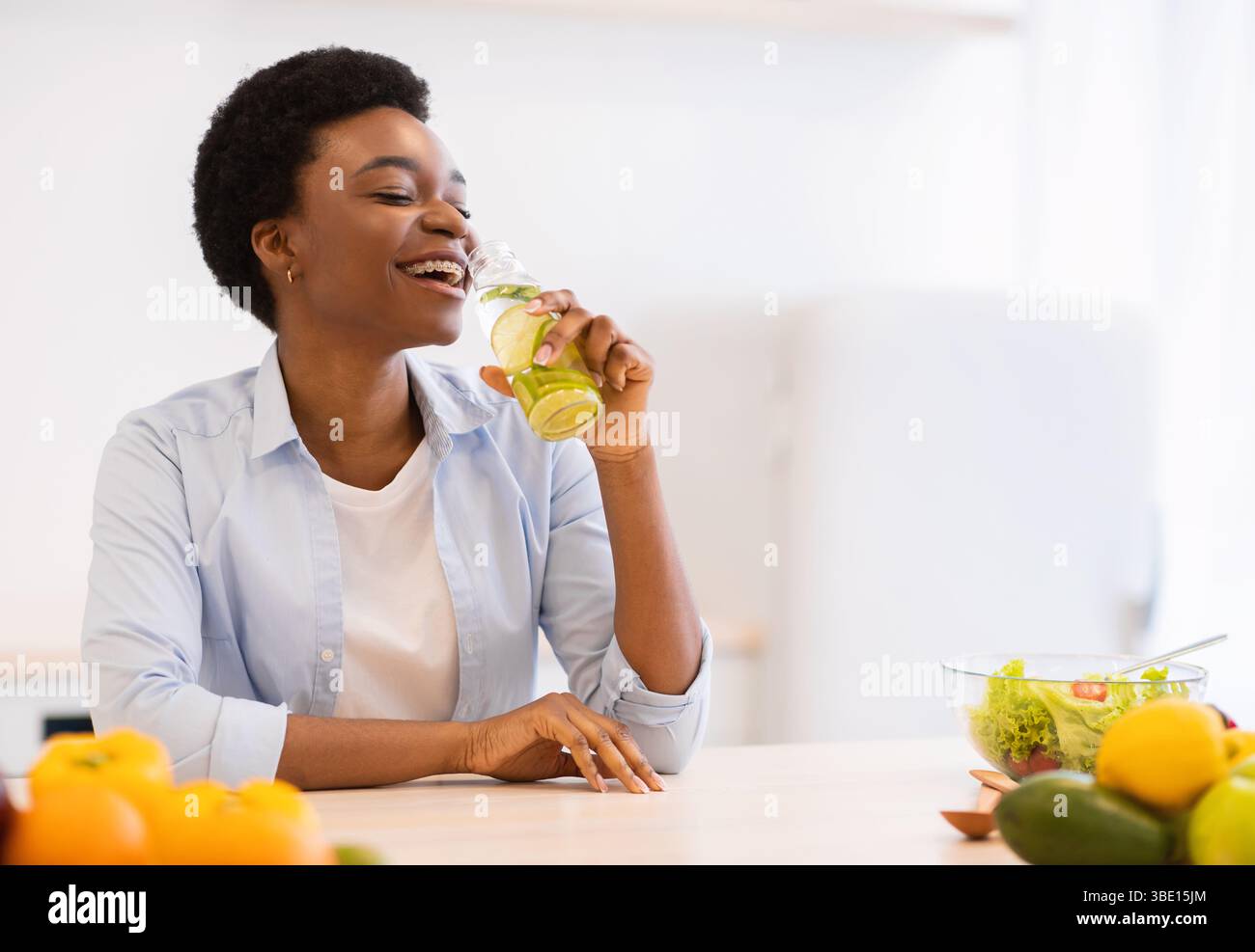 Black Woman Drinking Infused Water For Healthy Hydration In Kitchen ...