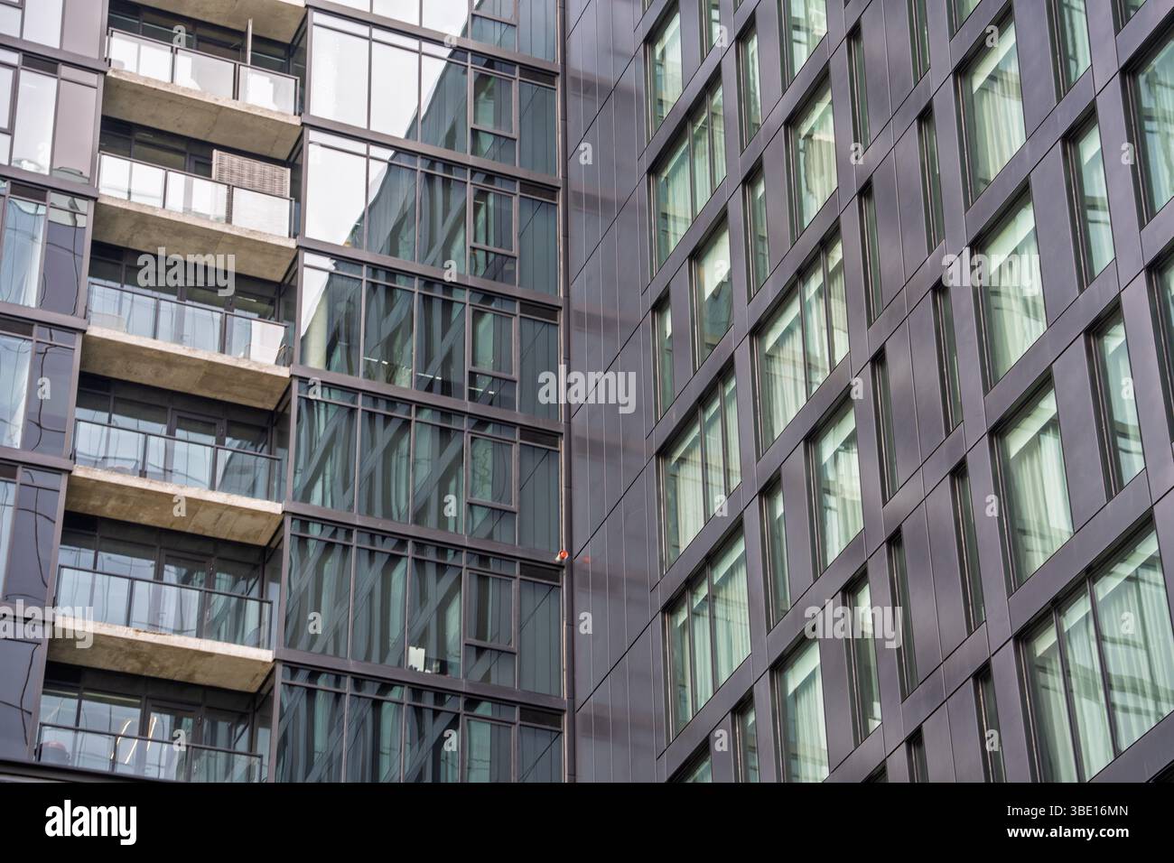 Large building with many windows and a balcony. The building is very ...