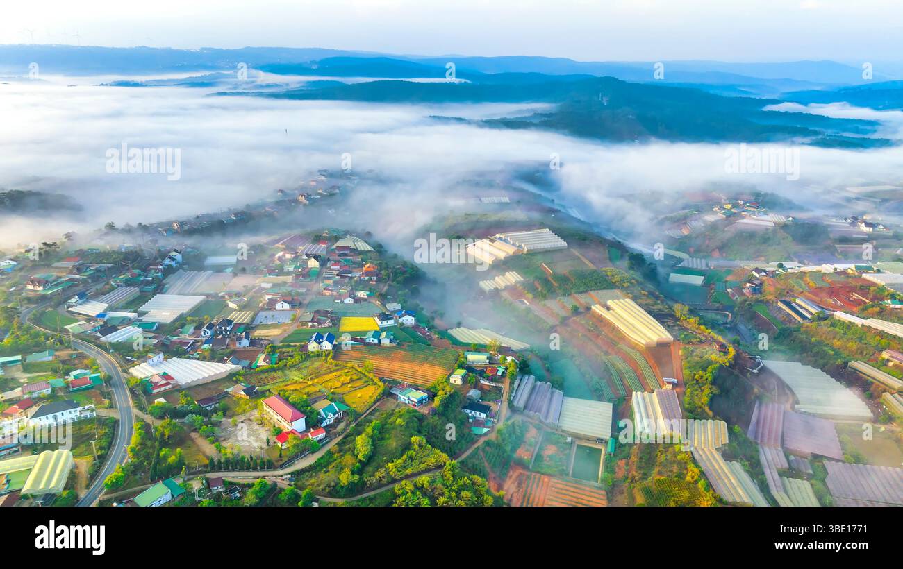 Aerial view of Xuan Tho suburbs near Da Lat city at morning with misty ...