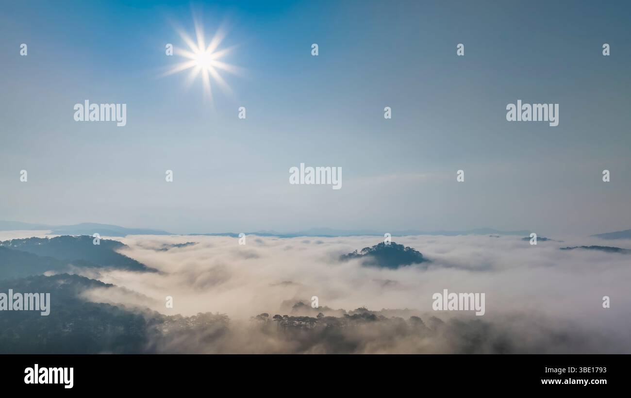 Aerial view of sunrise over the clouds with overlapping mountain ranges ...