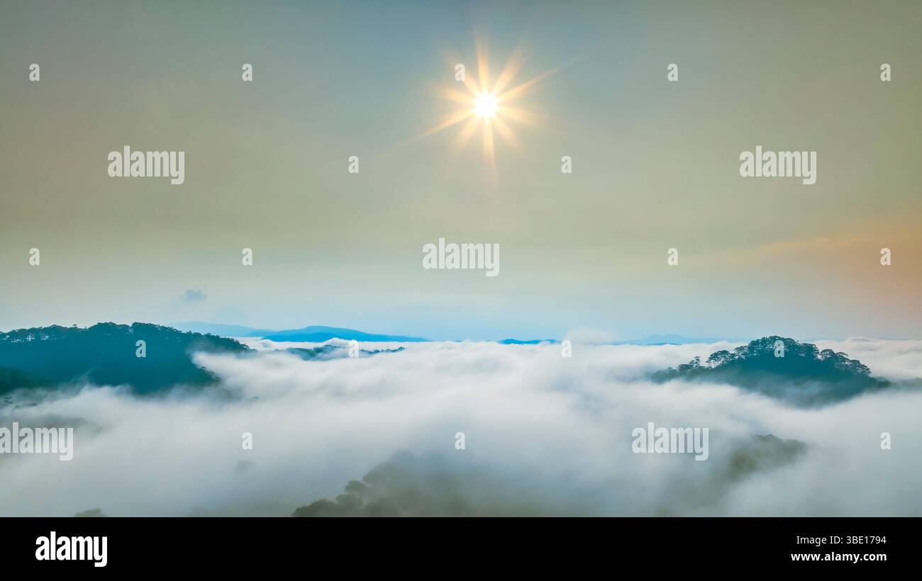Aerial view of sunrise over the clouds with overlapping mountain ranges ...