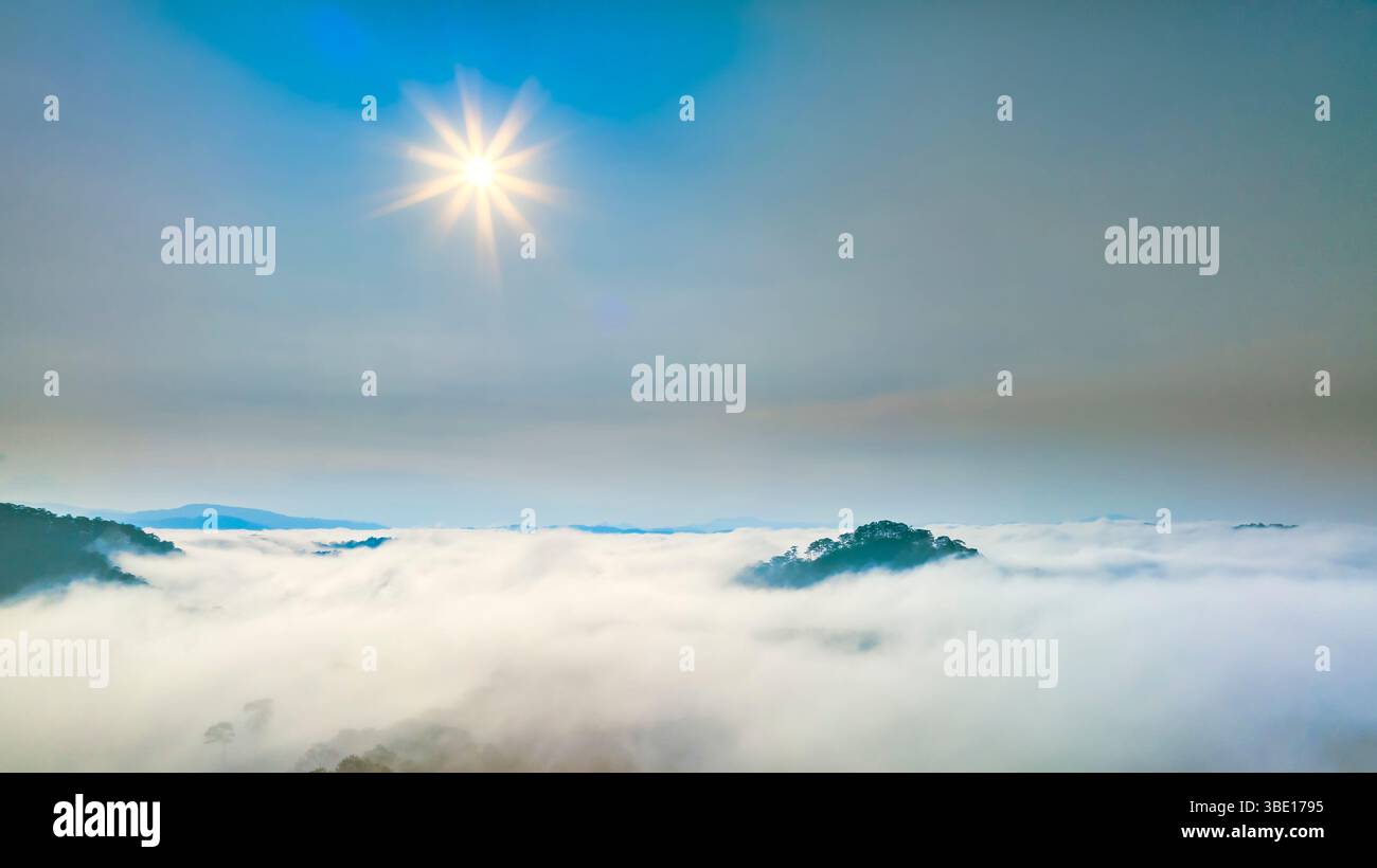 Aerial view of sunrise over the clouds with overlapping mountain ranges ...