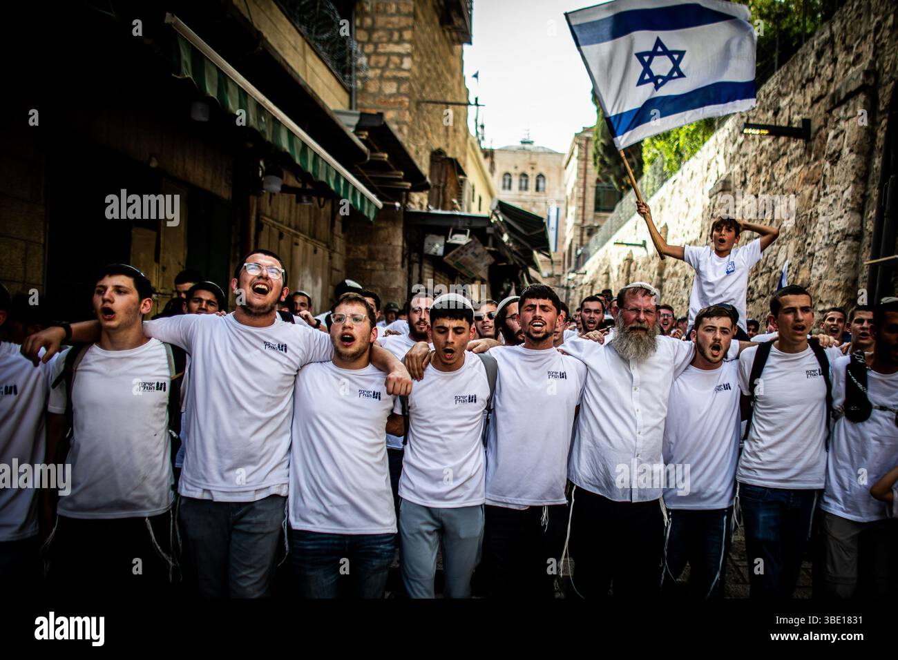 Israeli right wing youths dance with their Rabbi as they march through ...