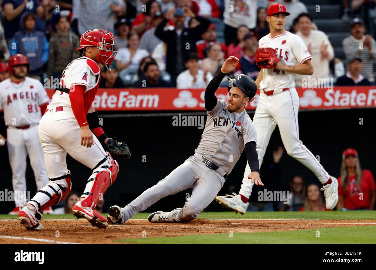 New York Yankees' Cody Bellinger, center, slides to score with Los ...