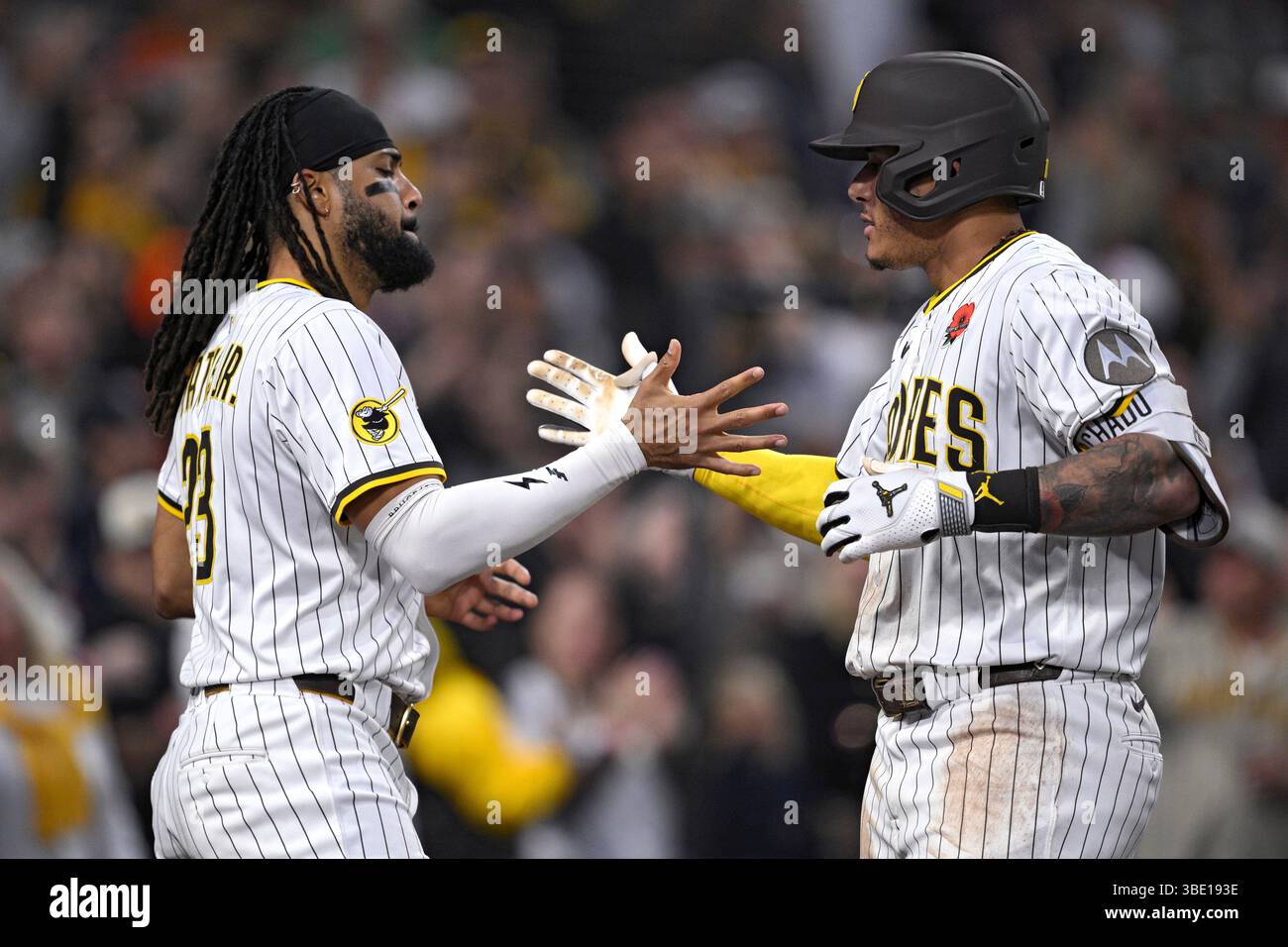 San Diego Padres' Manny Machado, right, celebrates with Fernando Tatis ...