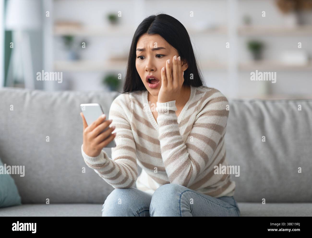 Oh No. Shocked Asian Woman Reading Bad Message On Smartphone At Home ...