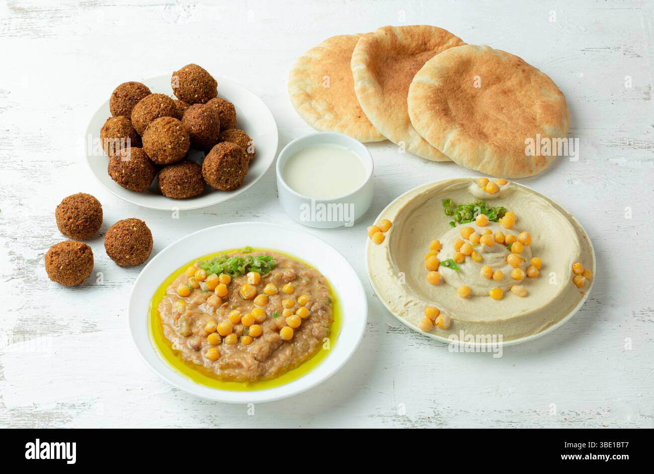 Traditional Arabic breakfast spread including falafel, hummus, foul ...