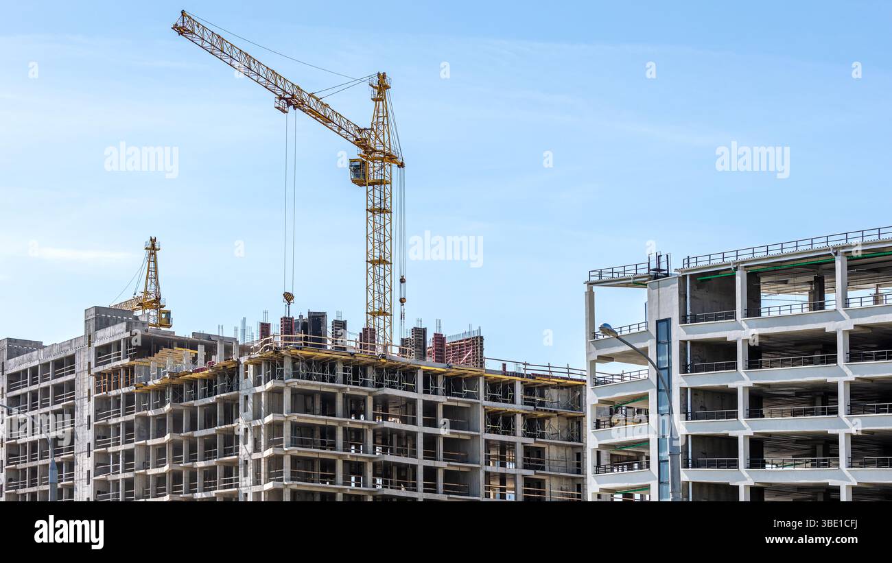 apartment building and multilevel parking garage under construction ...