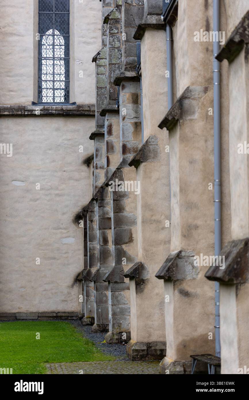 Rows of weathered buttresses provide structural support to an aging ...