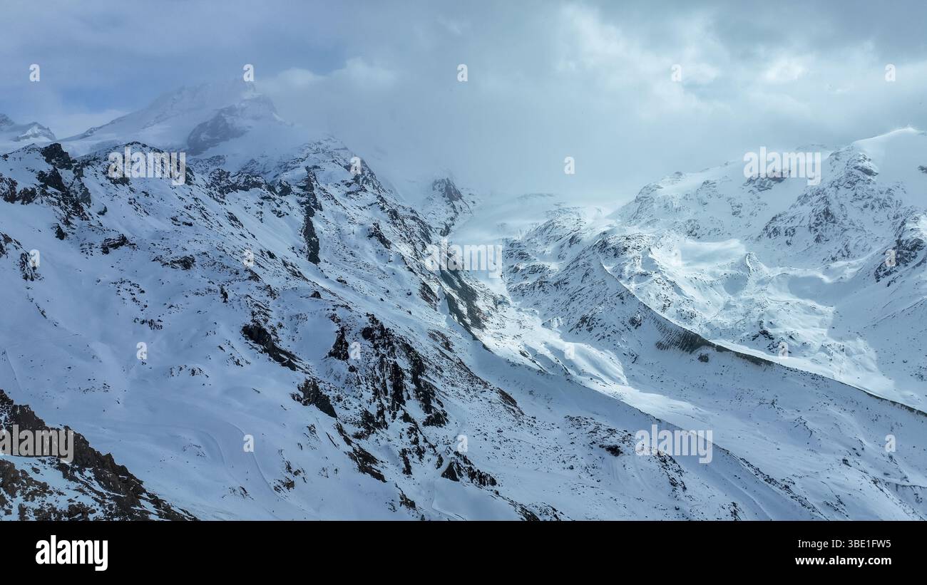 mountain peaks in the clouds. misty mountain peaks. snowy peaks Stock ...