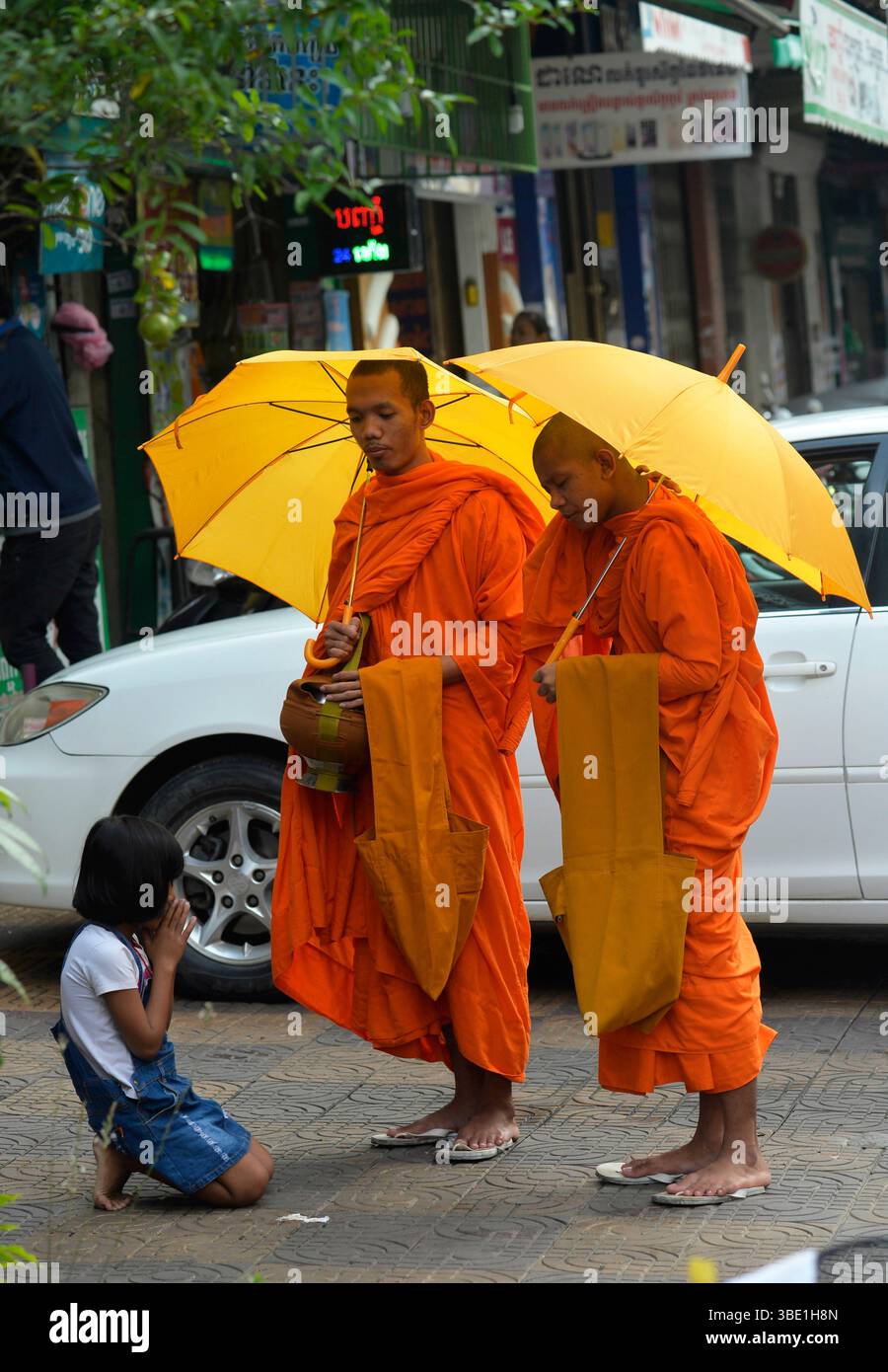 Buddhist monks receiving early morning food alms in Phnom Penh,Cambodia ...