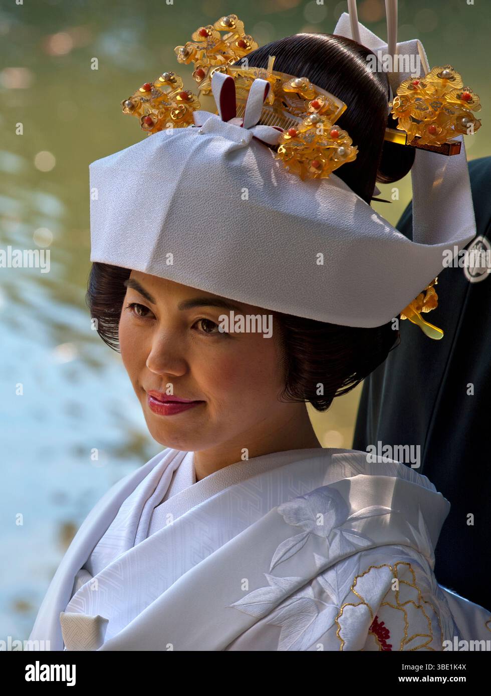 Japanese wedding bride wearing traditional "shiromuku" white kimono and headdress called a ...
