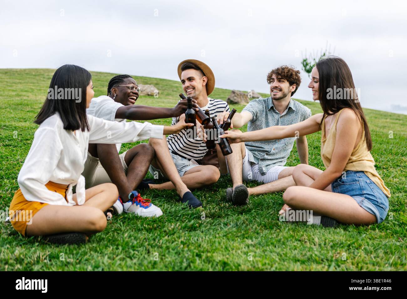 Young group of diverse friends having fun drinking beer during summer ...