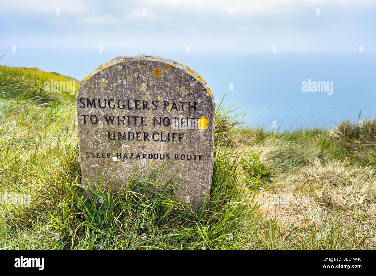 Stone marker sign for the Smugglers Path on the Dorset coast. leading ...