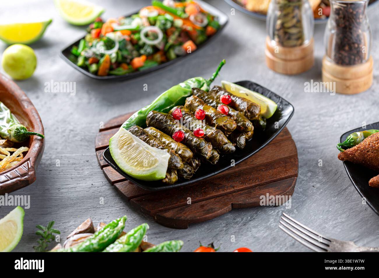 Arabic Eastern appetizer platter with grape leaves and pomegranate ...