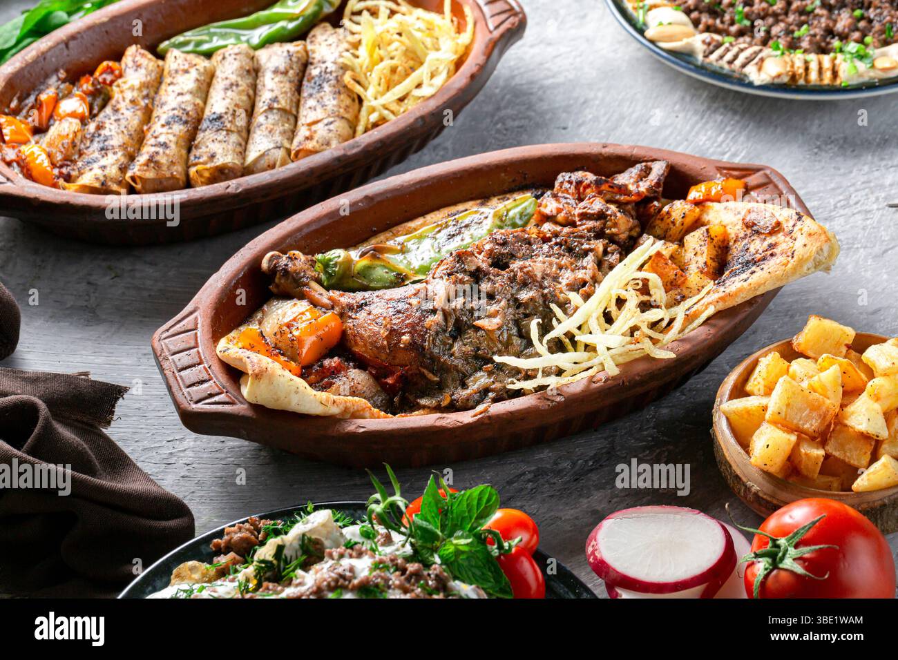 Grilled chicken leg with vegetables, potatoes, chips, and musakhan roll ...