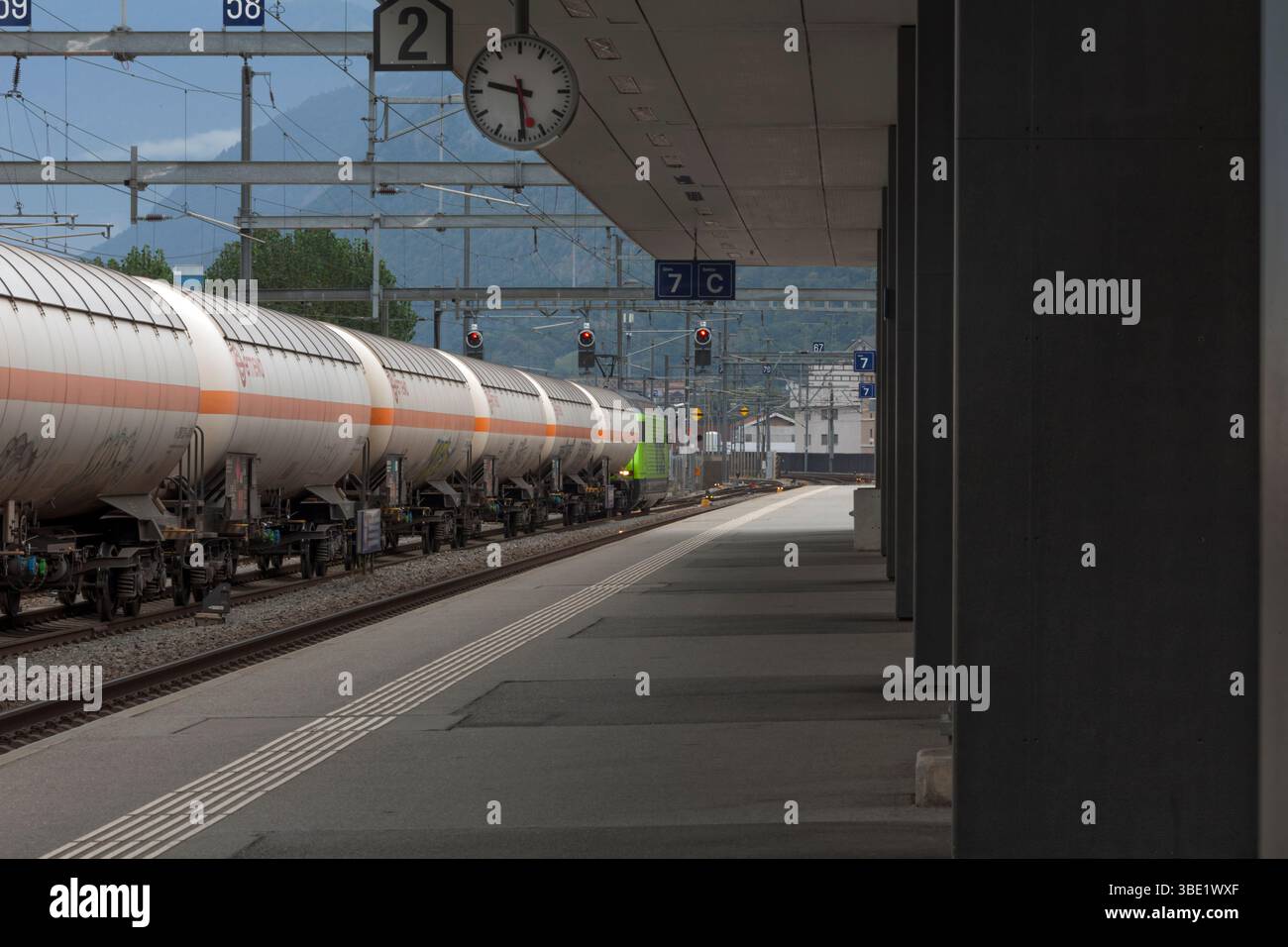 A rail freight train of pressure tanks waiting to head east at Visp ...