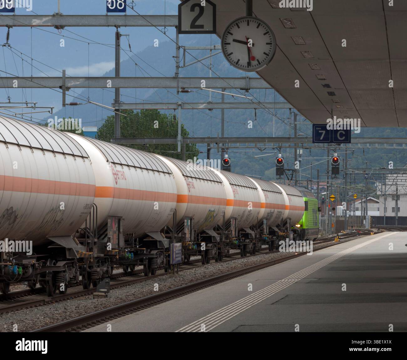 A rail freight train of pressure tanks waiting to head east at Visp ...