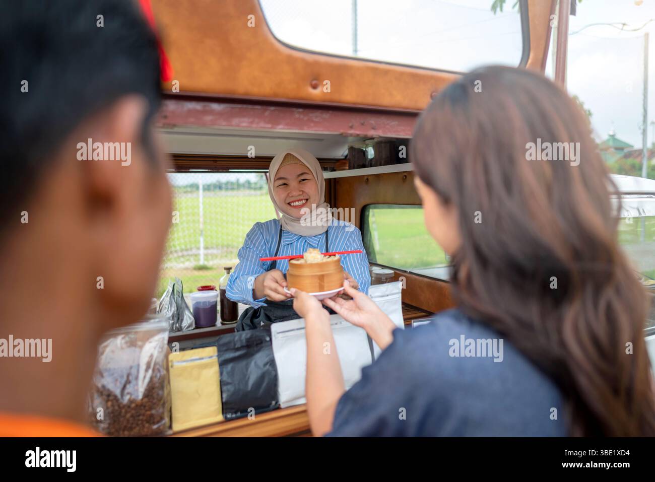 Indonesian southeast asian chinese muslim female waiter in hijab ...