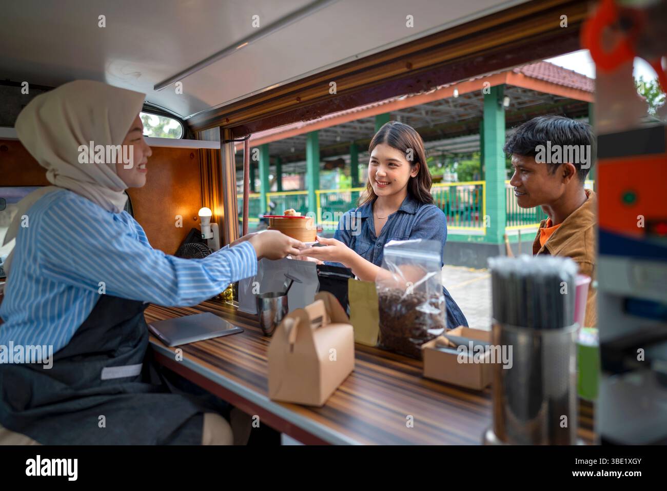 Indonesian southeast asian chinese muslim female waiter in hijab ...
