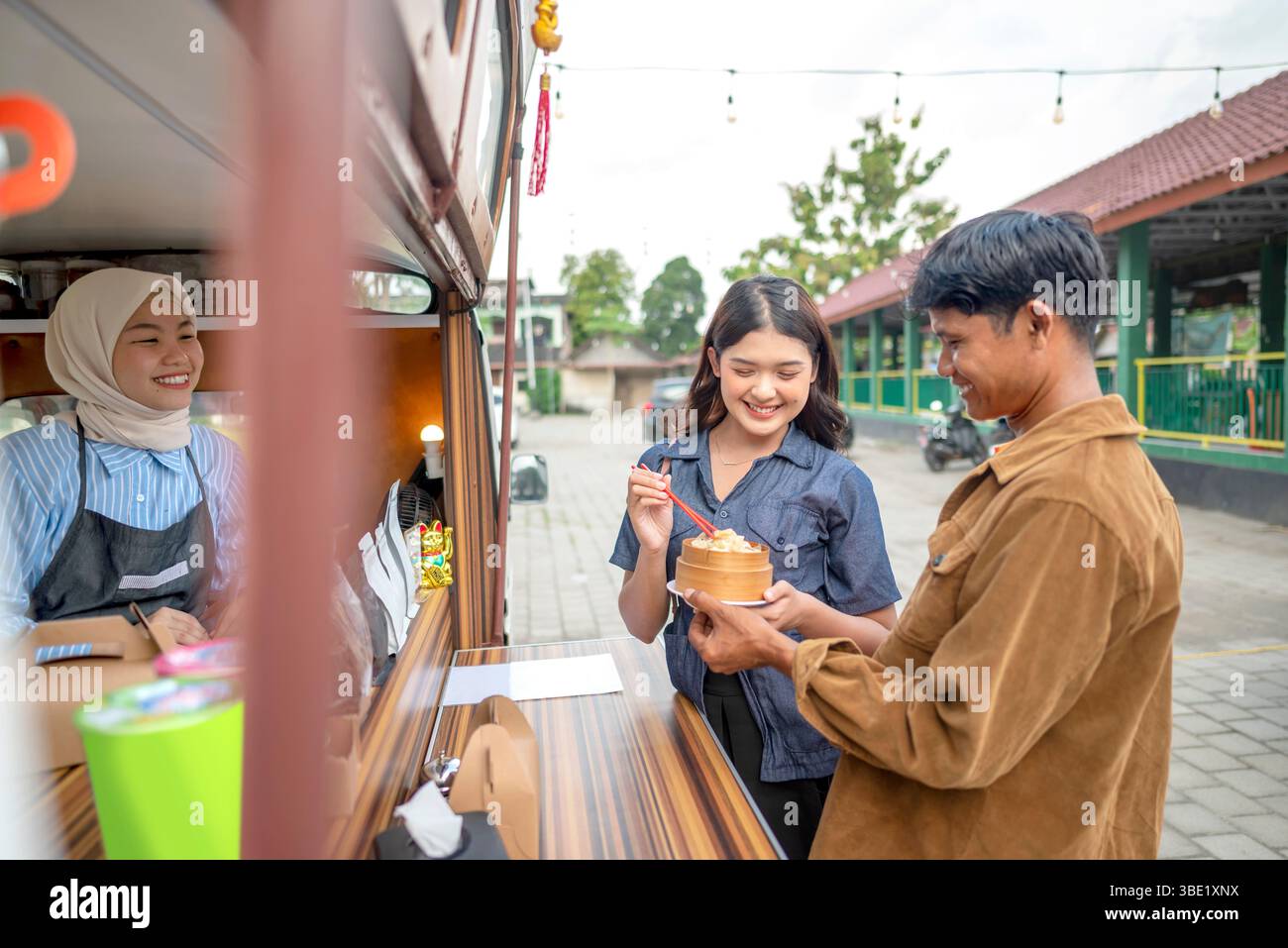 Indonesian southeast asian chinese muslim female waiter in hijab ...