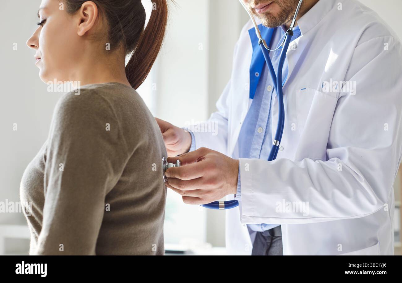 Female patient sitting in exam room in clinic for a medical checkup ...