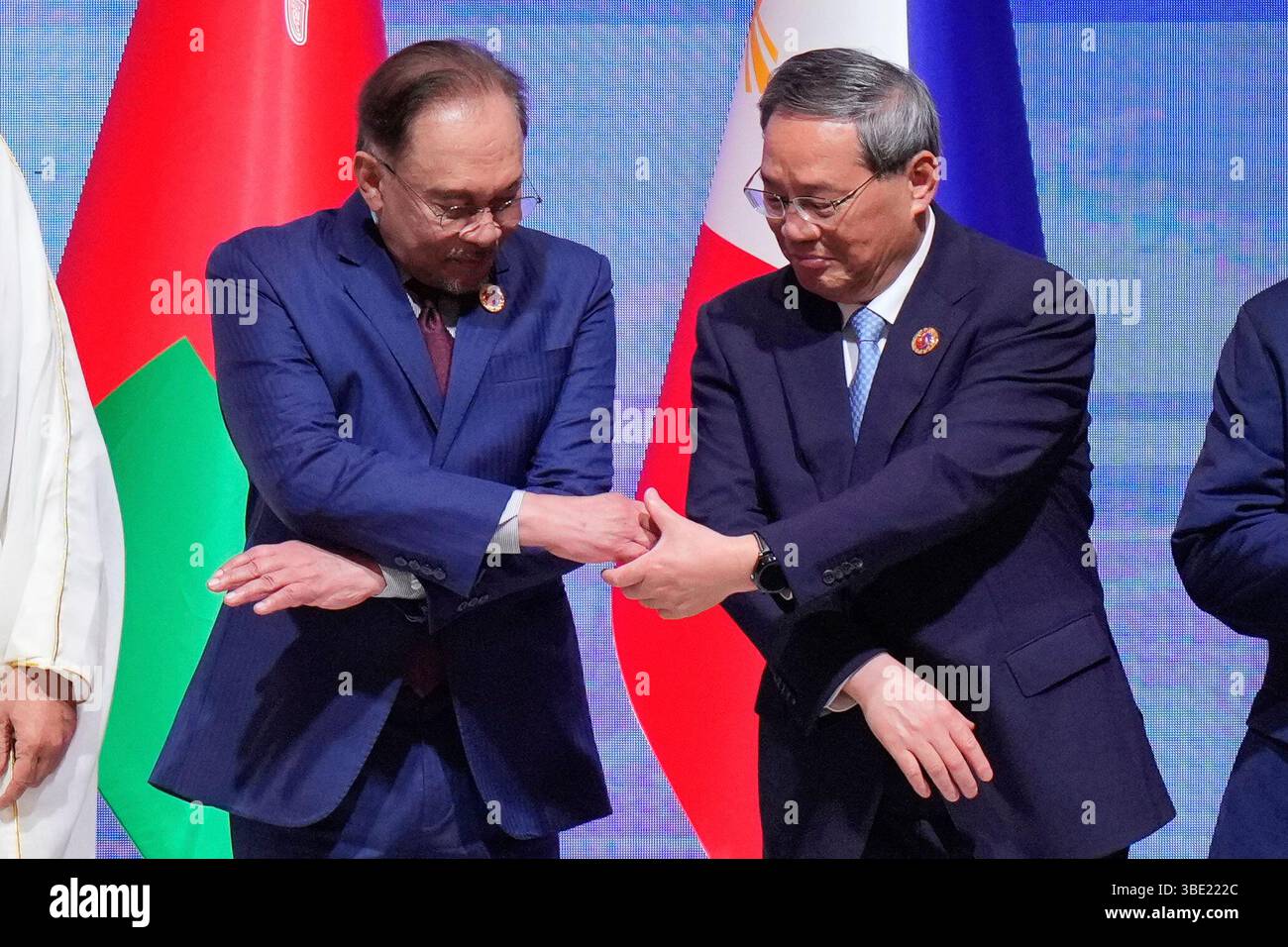 Malaysia's Prime Minister Anwar Ibrahim, left, chains a hand with China ...