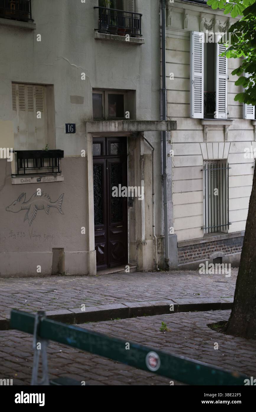 European Building Facade with Fish Graffiti, Number 16, and Cobblestone ...