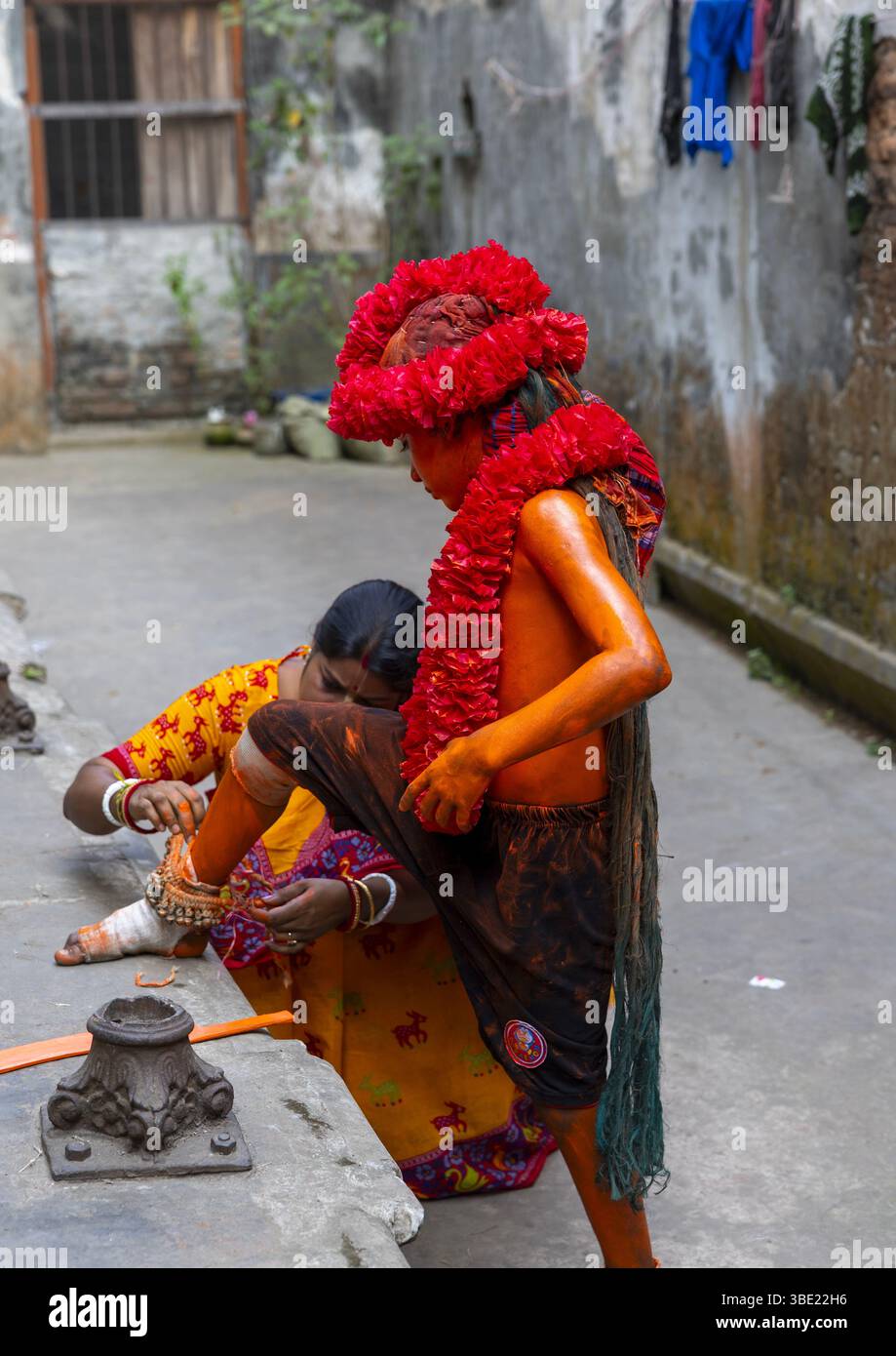 Young Hindu devotee covered with orange color dressing at Lal Kach festival, Dhaka Division ...