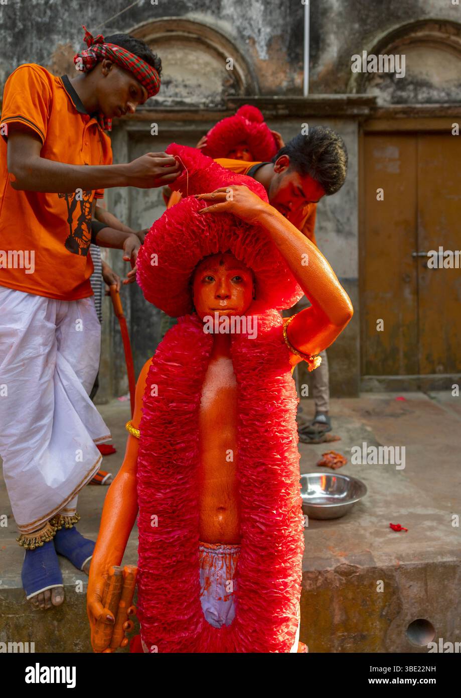 Dressing of a Hindu devotee covered with orange color at Lal Kach festival, Dhaka Division ...