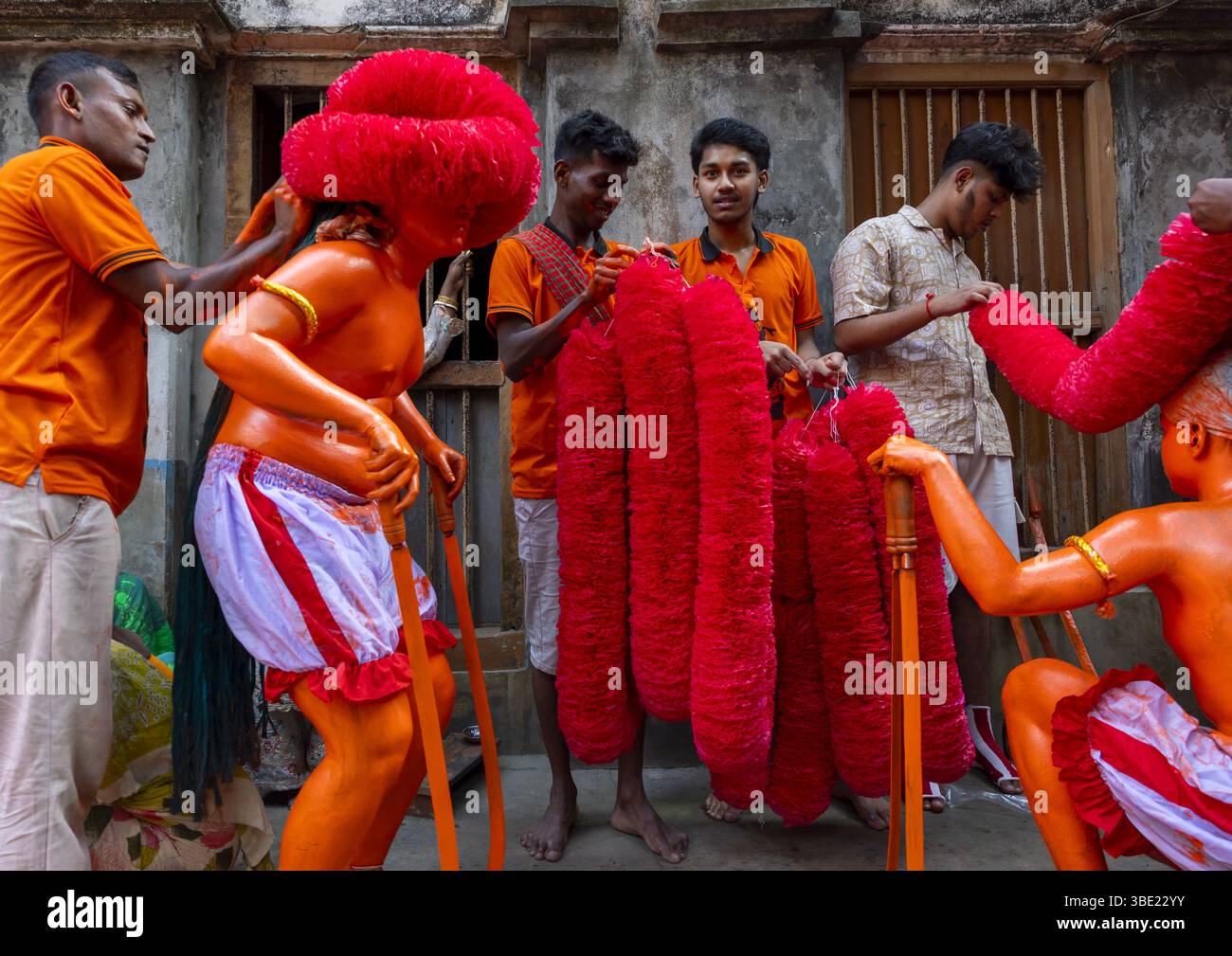 Dressing of a Hindu devotee covered with orange color at Lal Kach festival, Dhaka Division ...