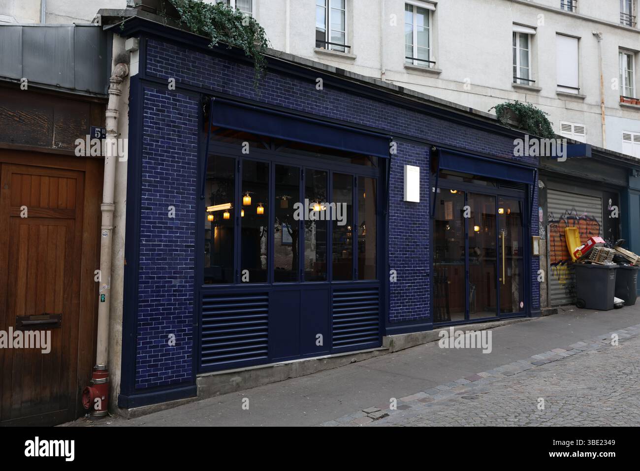 Modern Blue Brick Restaurant on Sloping Parisian Cobblestone Street ...
