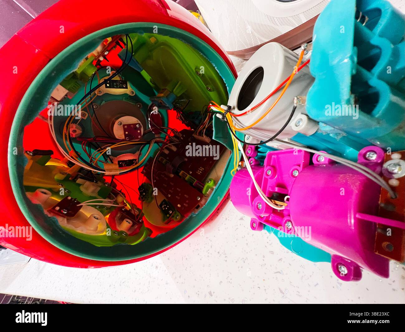 A detailed look inside a machine showing circuits, wires, and vibrant ...