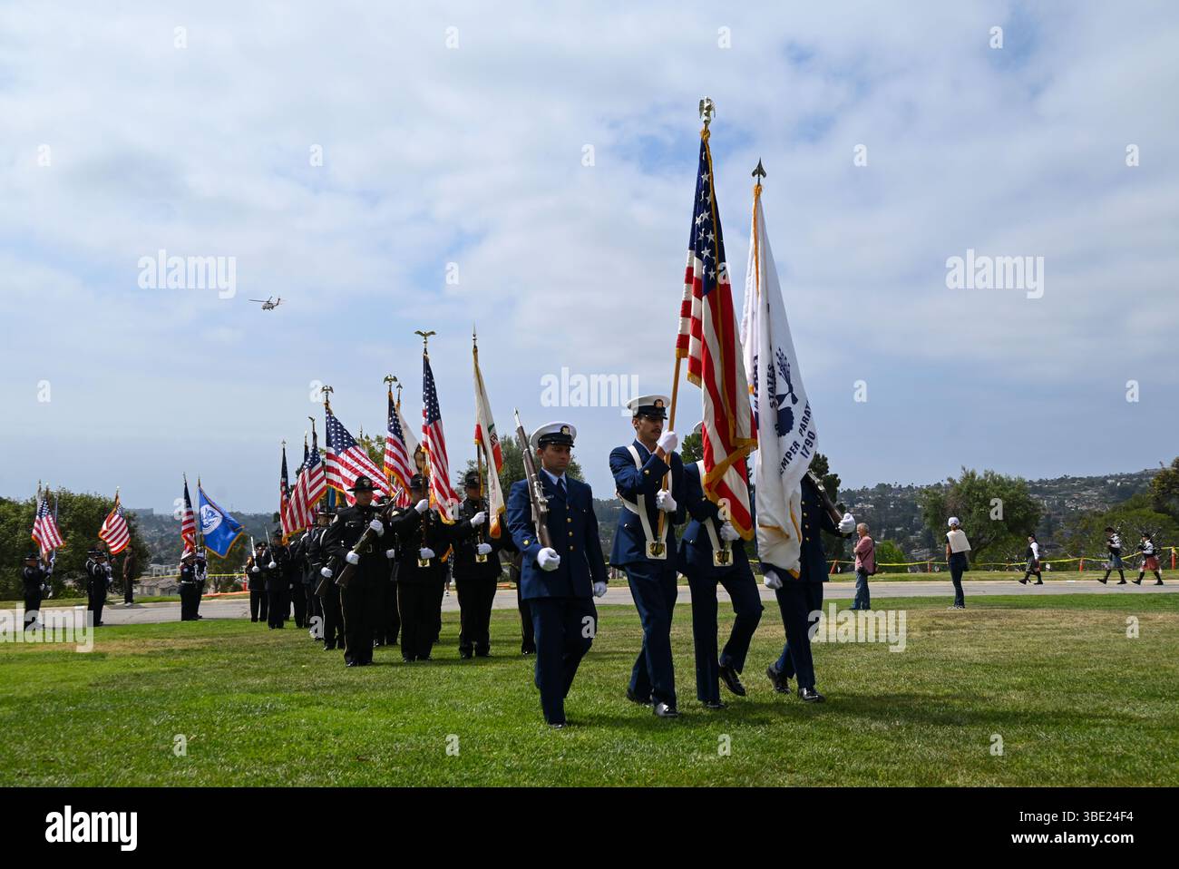 U.S. Coast Guard members participate in a joint-service color guard ...