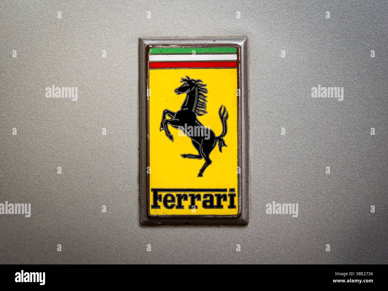Classic Ferrari emblem displayed on a metallic silver surface ...