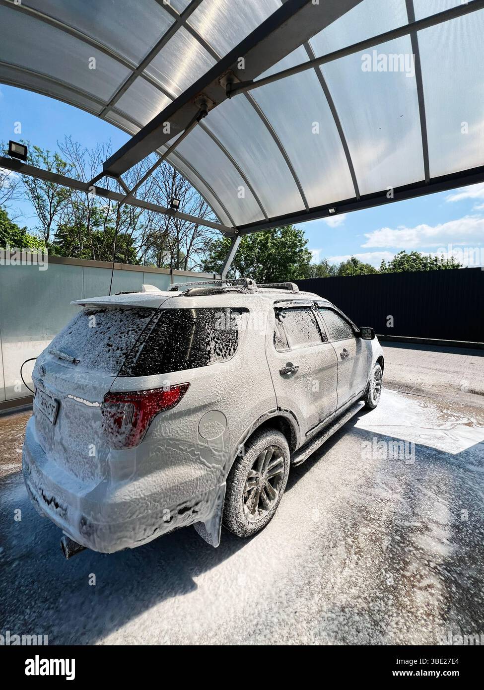 Kyiv, Ukraine - May 26, 2025: Ford Explorer car being cleaned with foam ...