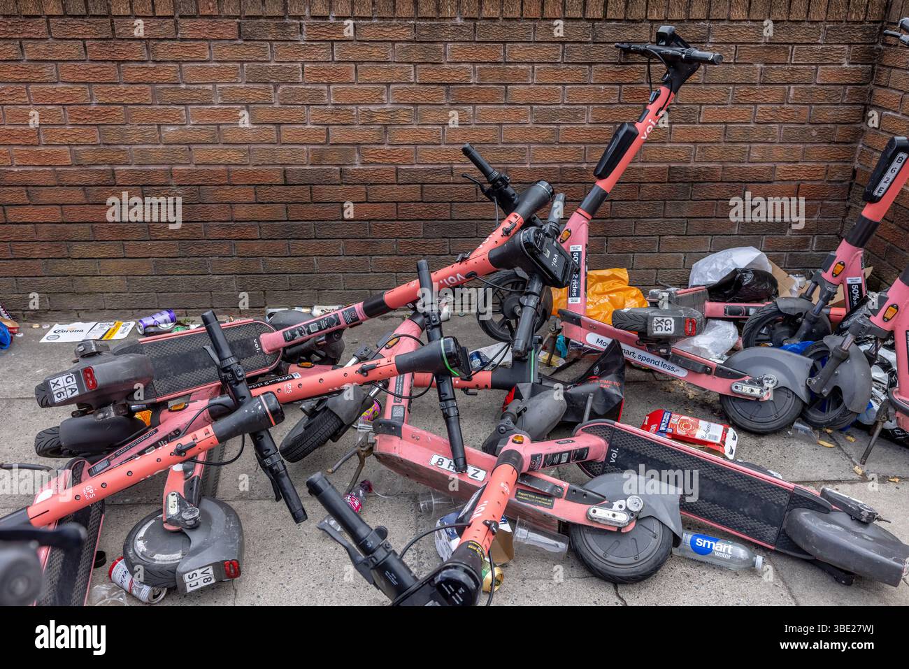 electric scooters dumped on pavement Stock Photo - Alamy