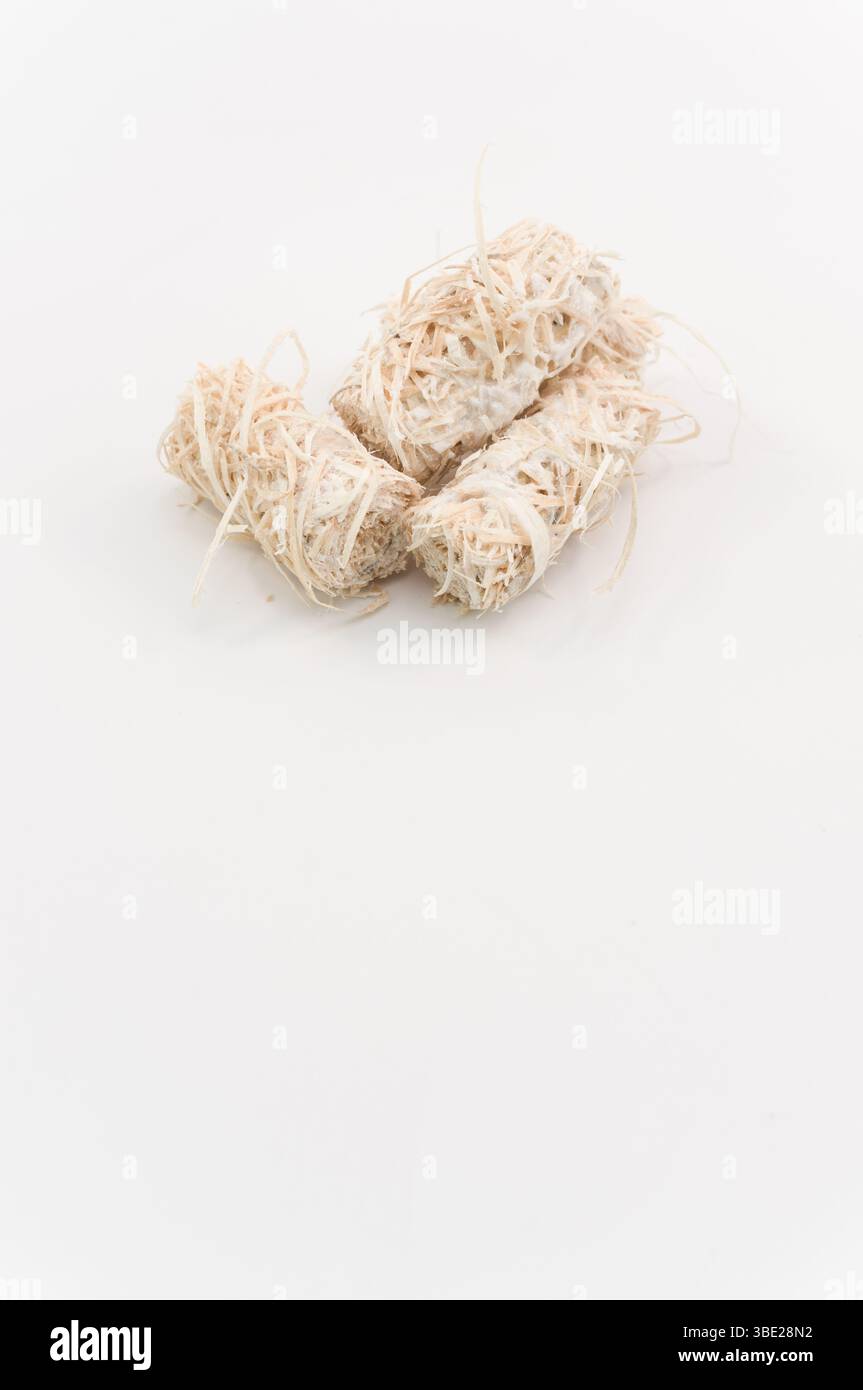 waxed wood shavings fire starter on a white background Stock Photo - Alamy