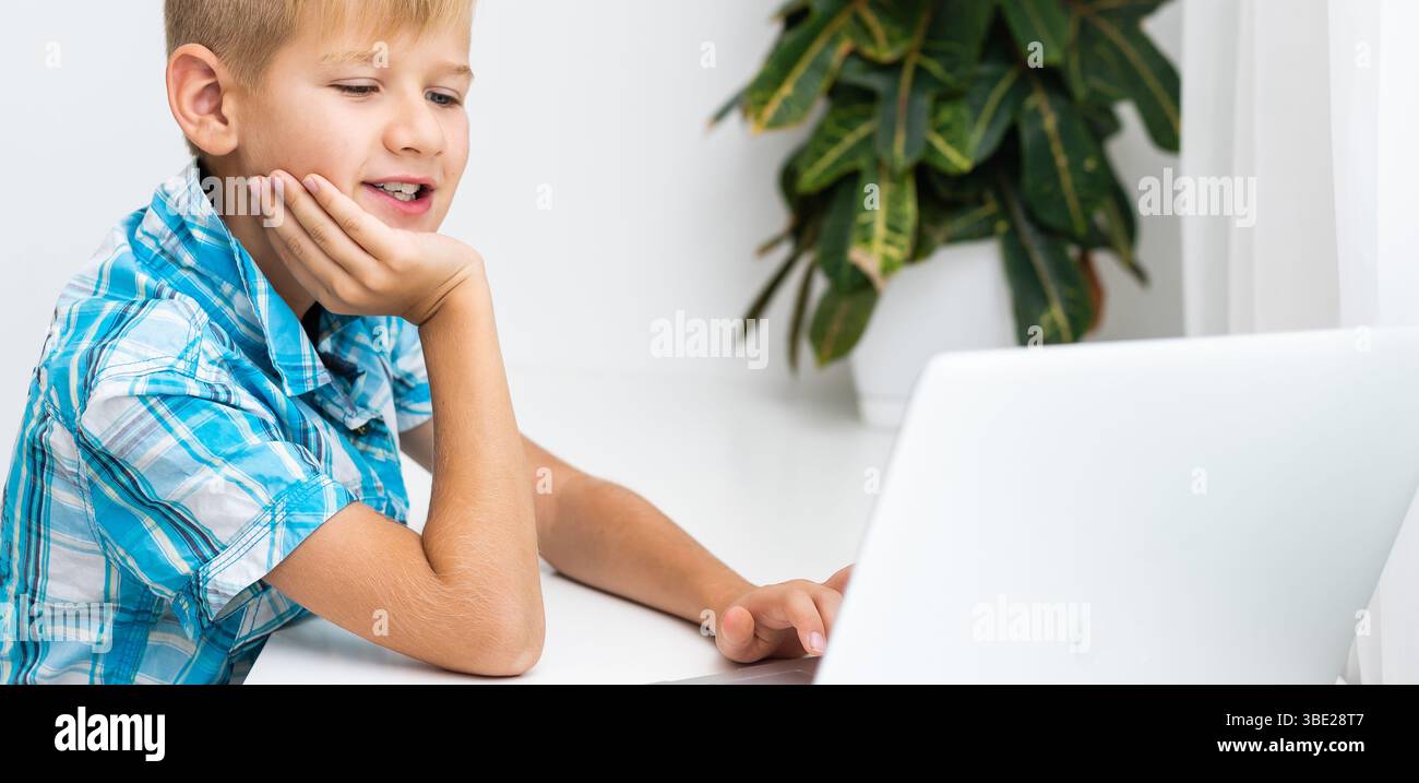 Smart Young Boy Works on a Laptop For His New Project in His Computer ...