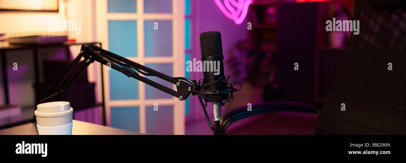 Recording studio featuring modern microphone on adjustable arm beside ...