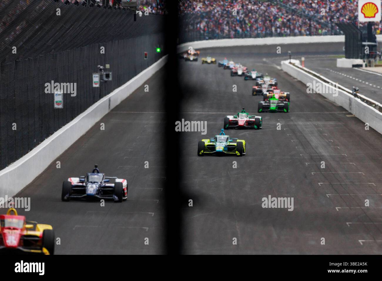 Cars roar past the yard of bricks during the NTT IndyCar Series 109th ...