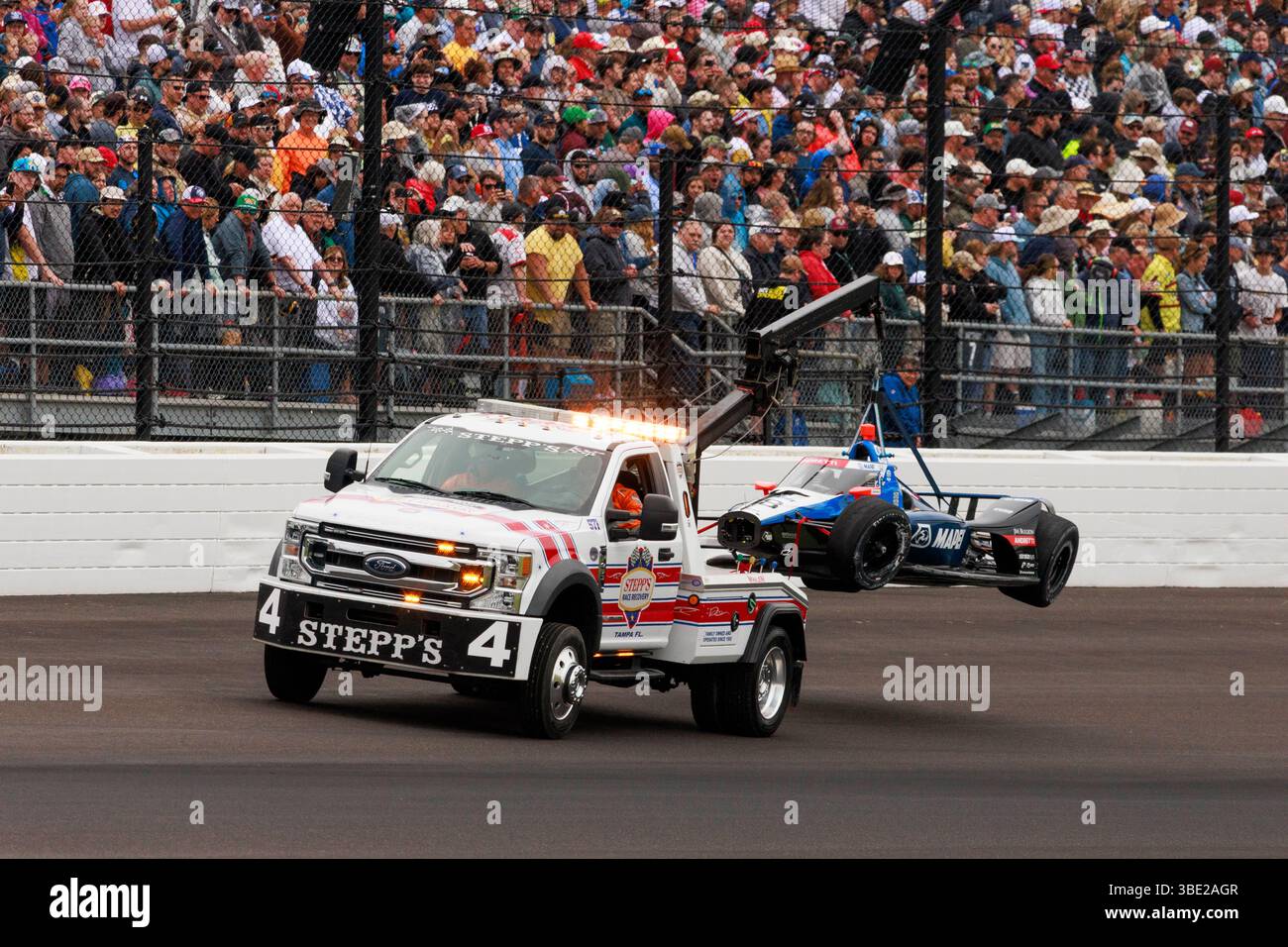 Marco Andretti’s car is taken to the garage by a tow truck after a ...
