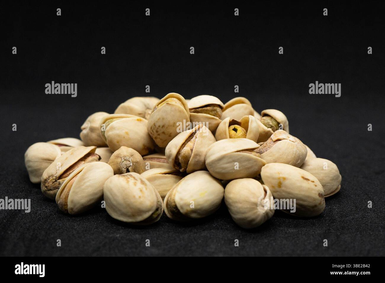 Roasted pistachio nuts in shell on black background (Antep Fistigi ...