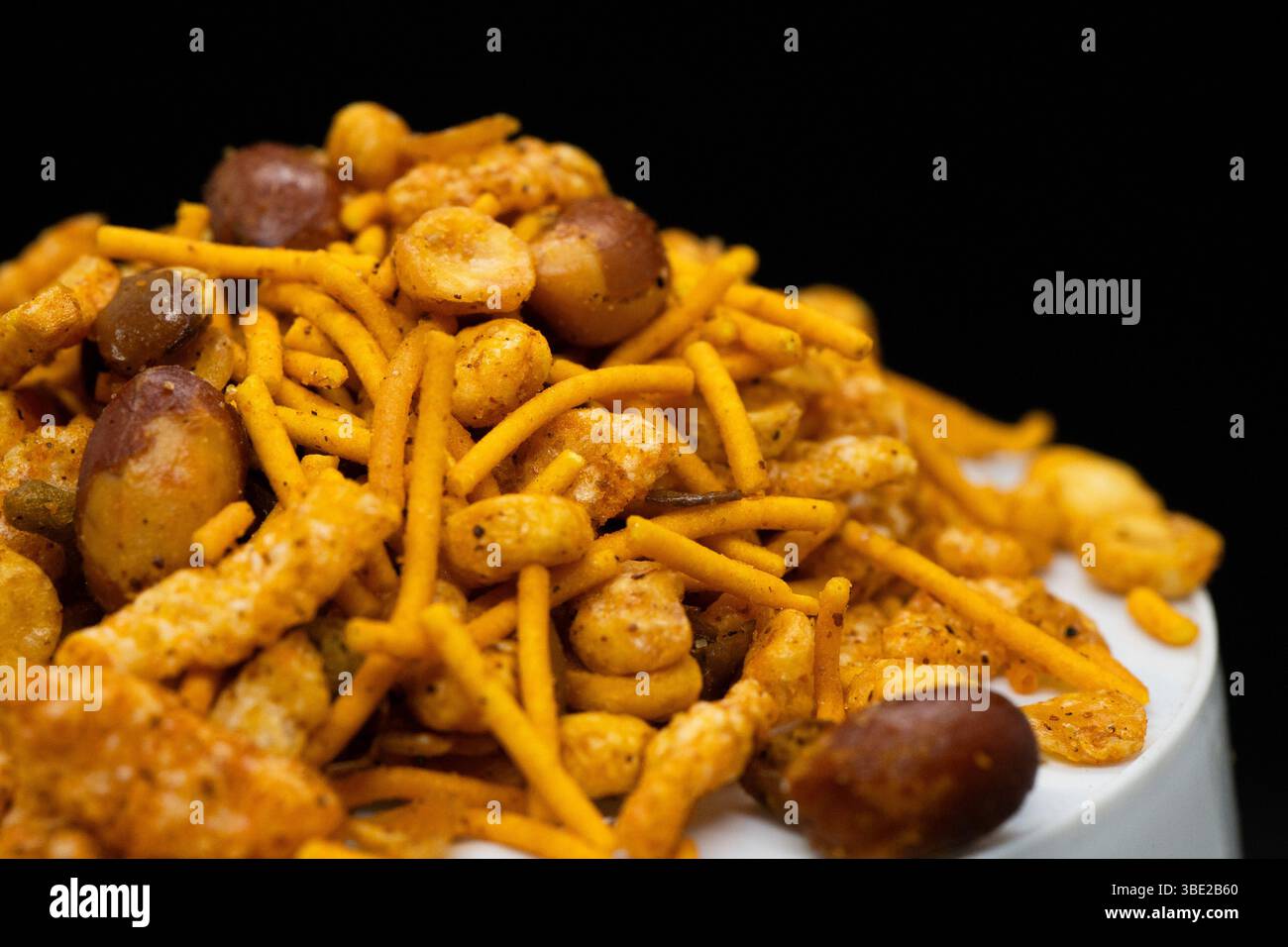 Hot spicy NavRatan mixture snacks in full-frame, made with, potato chips, peanuts, besan sev ...