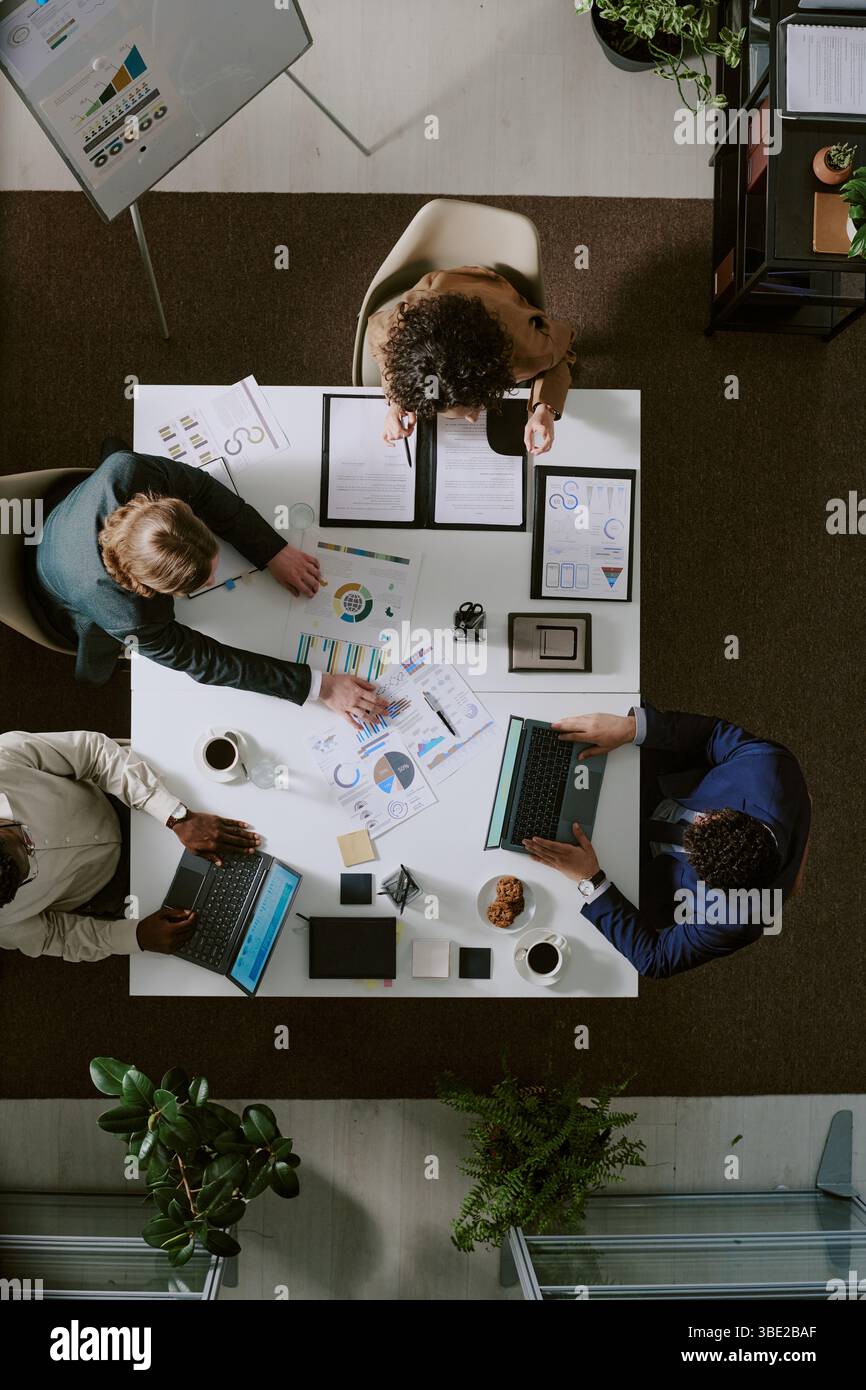 Team of diverse professionals collaborating in office, analyzing ...