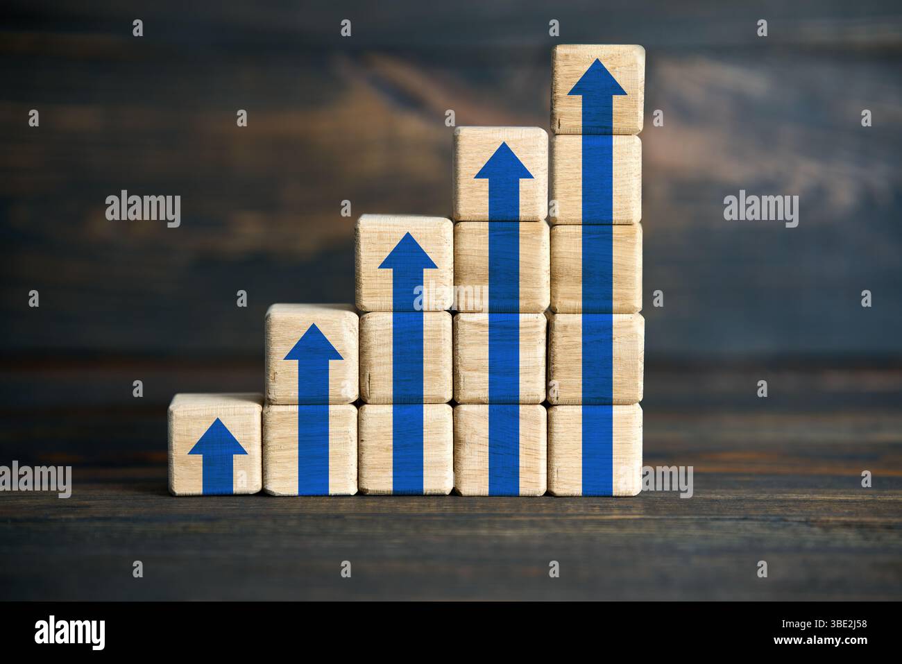 Wooden blocks stacked as blue arrow bar chart. Growth concept Stock ...