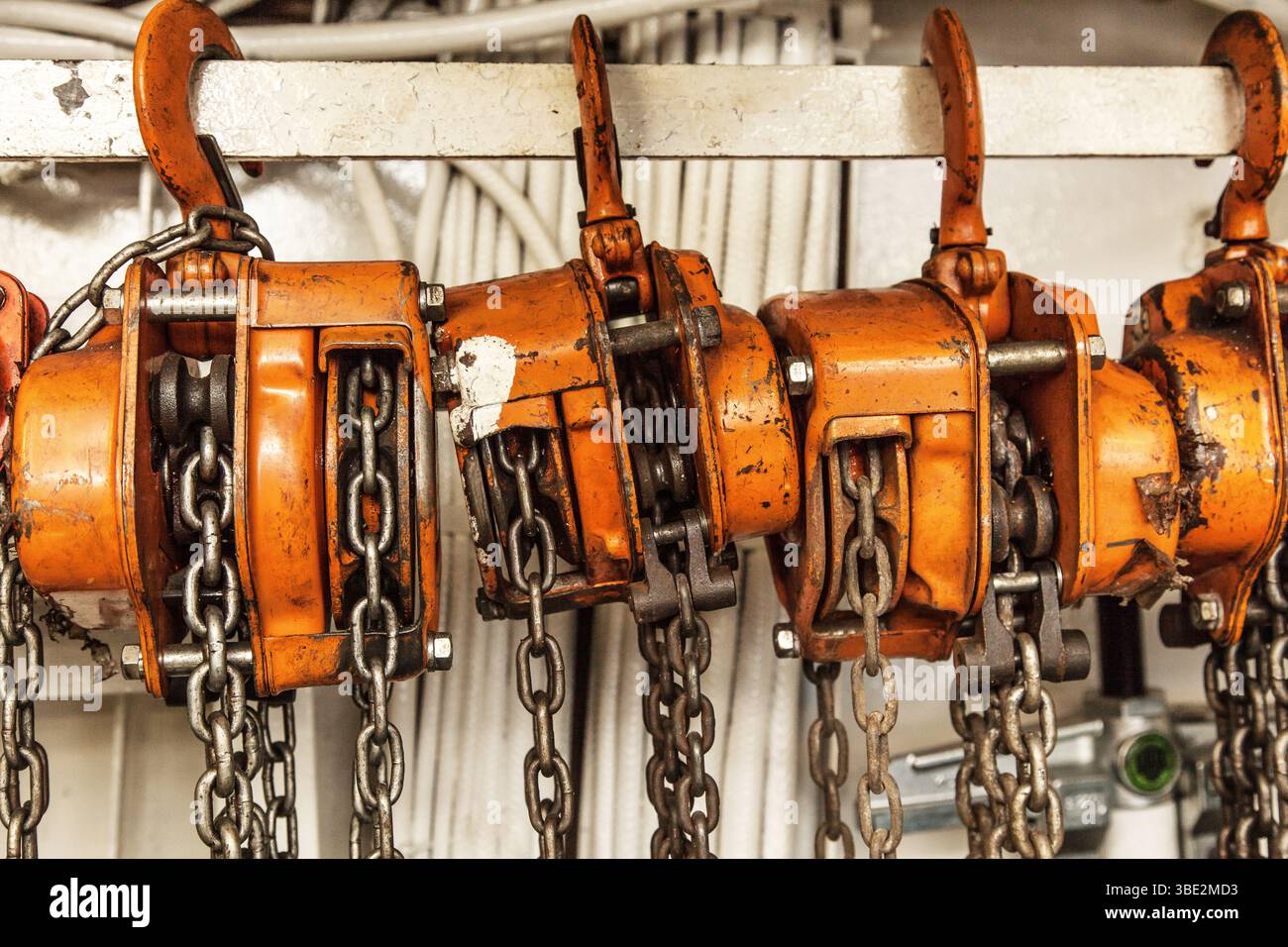 Chain hoists for lifting weights in a workshop close-up Stock Photo - Alamy