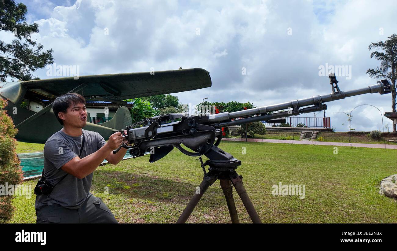 Asian man visits and holds old cannon, weapons used in past battles at ...