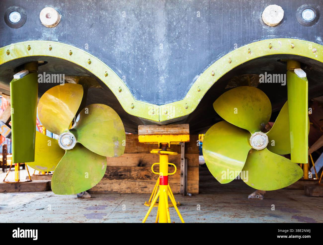 The back of a large motor yacht, standing on wooden blocks in a dry ...